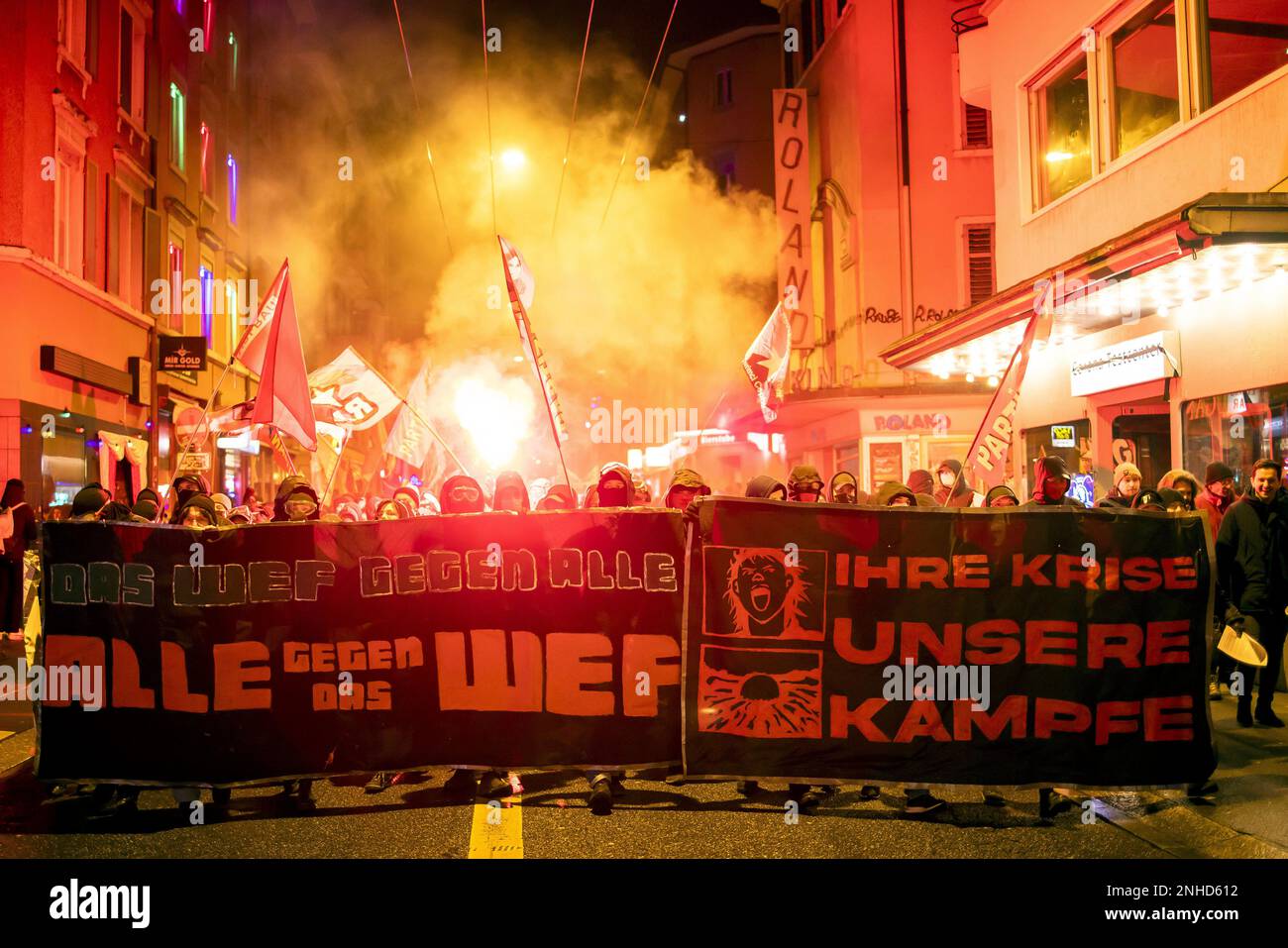 Protesters hold a banner reading "WEF against all, all against the WEF ...