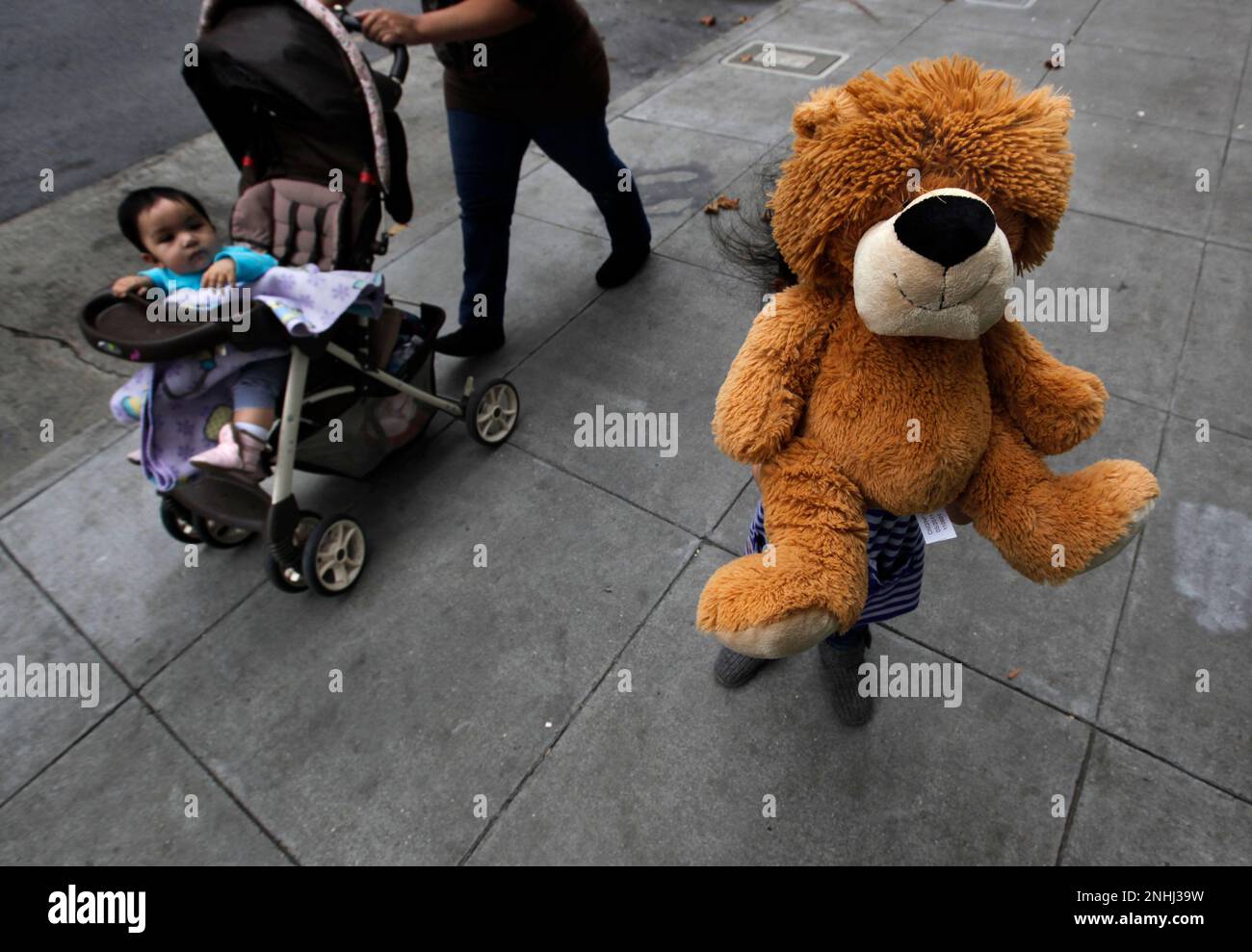 Celia Colon pushes her 10-month-old daughter Angie as her 5-year-old ...