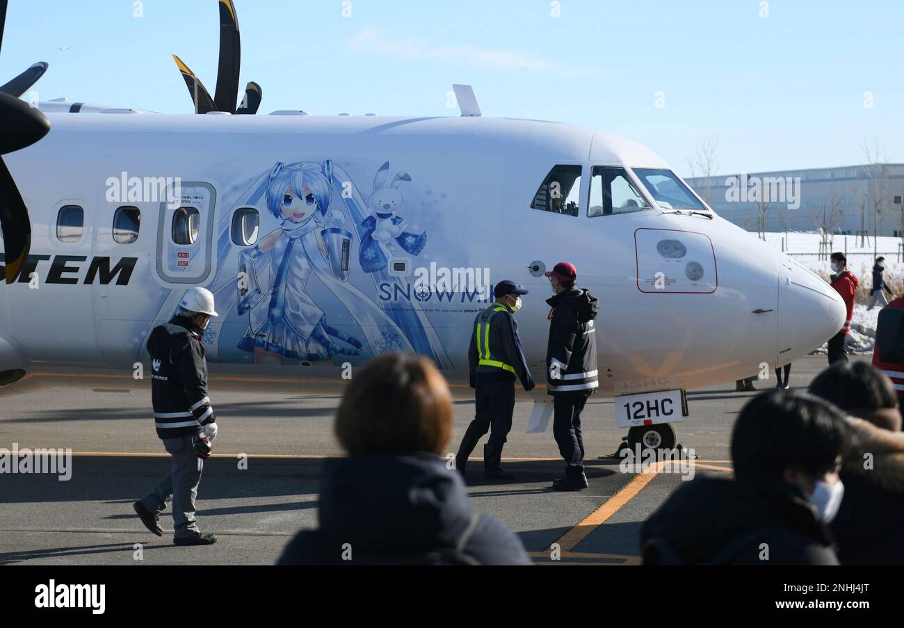 Passengers pose with Snow Miku, a supporting character to promote ...