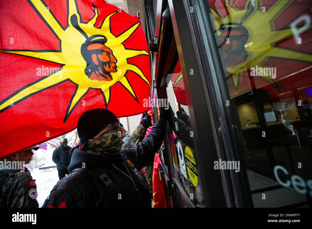 Members of the First Nations Indigenous Warriors bang on the locked ...