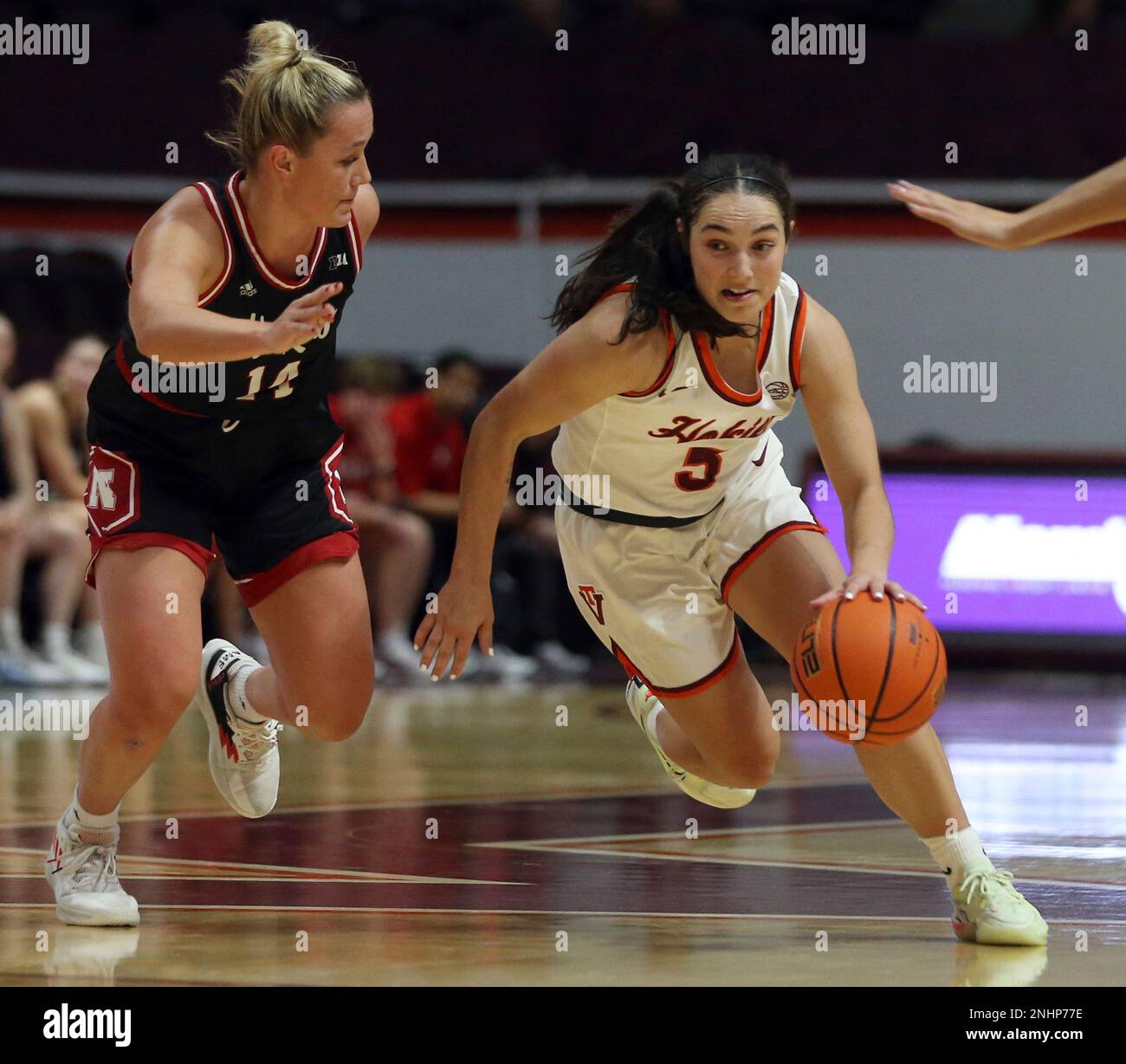 Virginia Tech's Georgia Amoore (5) drives past Nebraska's Callin Hake ...