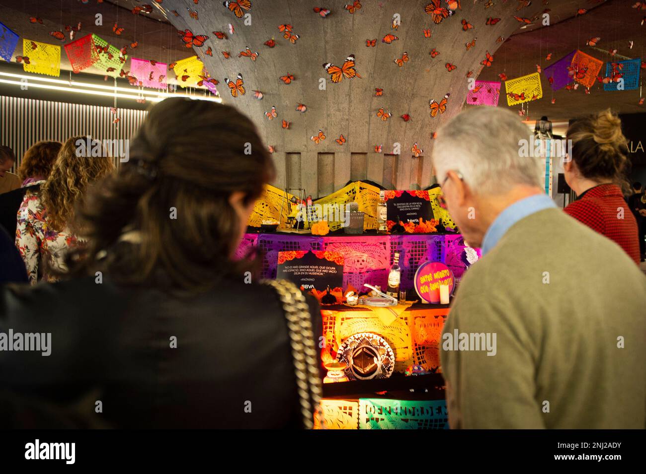 Several people look at an altar during the presentation of the Day of ...