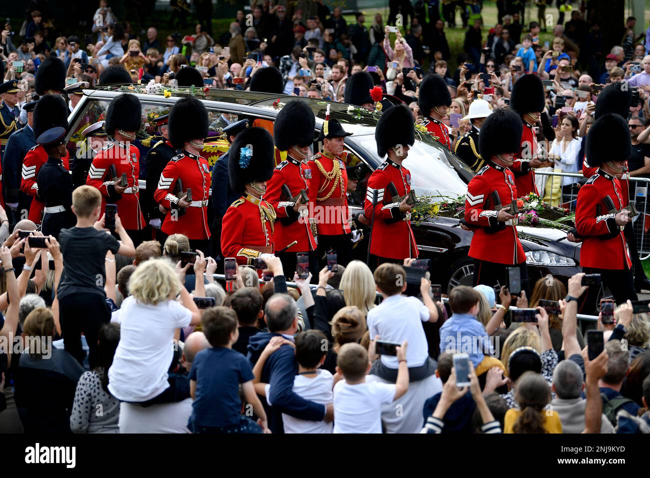 Members if the public watch the state hearse carrying the coffin of ...