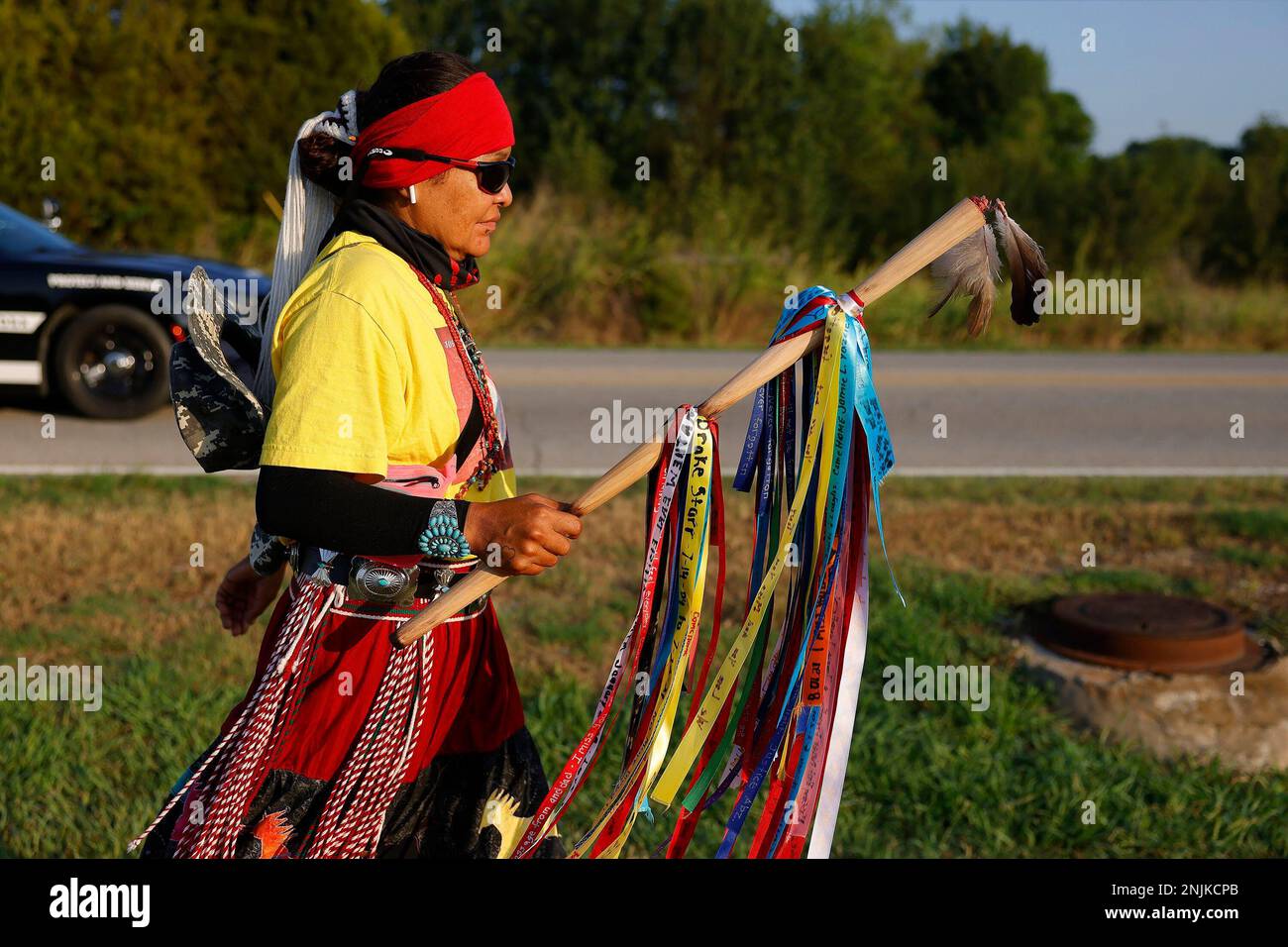 Seraphine Warren carries a prayer staff as she walks on her "Trailing ...