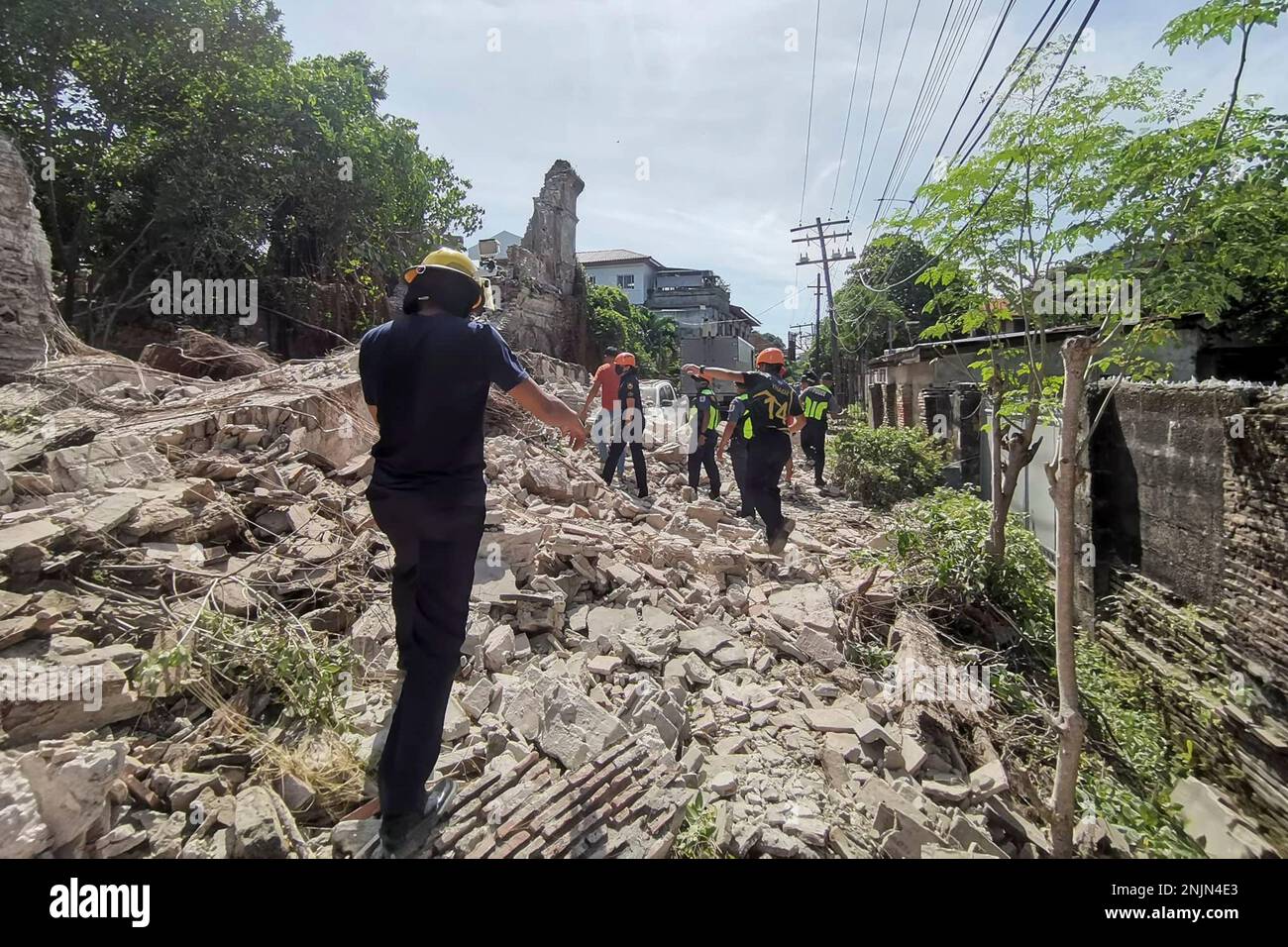In this photo provided by the Bureau of Fire Protection, rescuers walk ...