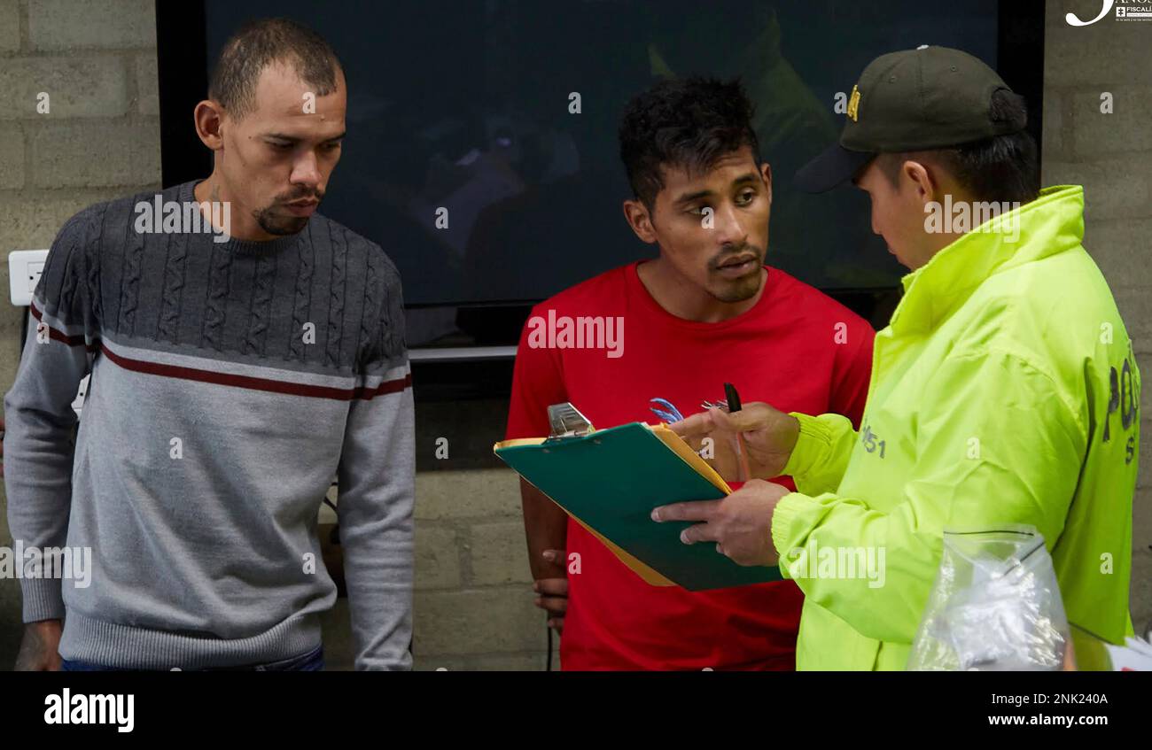 In this handout photo released by Colombia's Attorney General Press Office, police interview ...