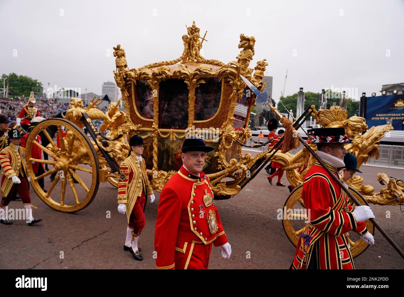 The image of Queen Elizabeth II is seen in a golden carriage during the ...
