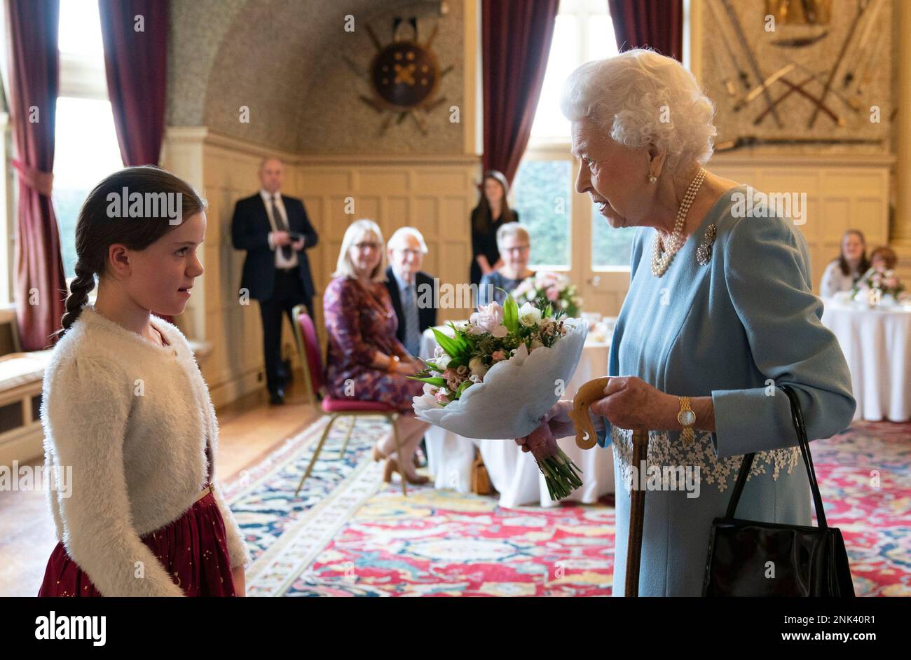 FILE - Britain's Queen Elizabeth II receives a posy from Harriet Reeve ...