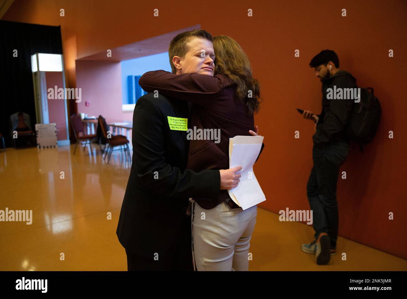 From left: Evan Minton and Amy Brown embrace after Minton addressed the ...