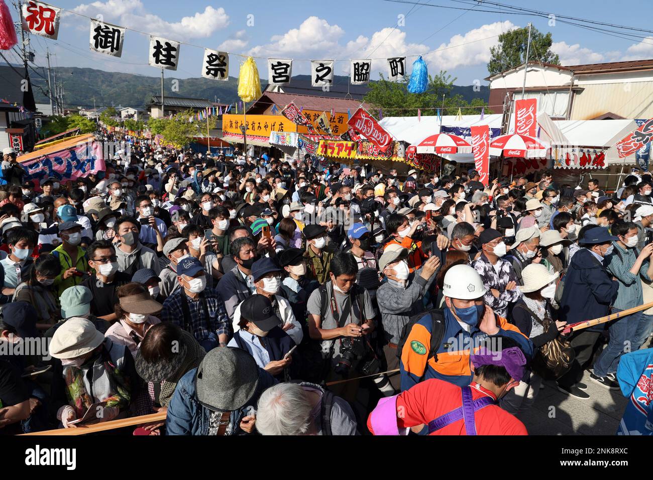 Parishioners of Suwa Shrine ride a huge tree for Onbashira Matsuri ...