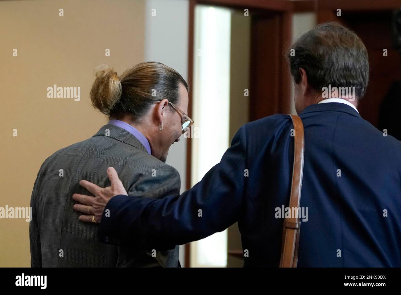 Attorney Ben Chew leaves with his client, actor Johnny Depp at the ...