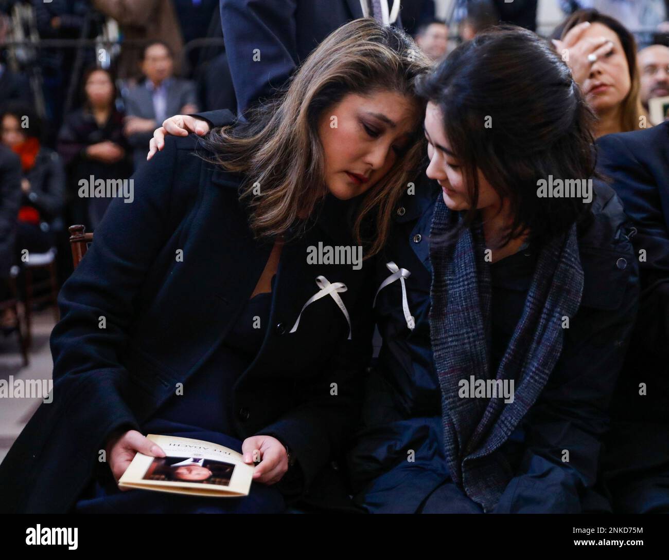 Mutsuko Adachi (left) rests her shoulder on daughter Lauren Adachi ...