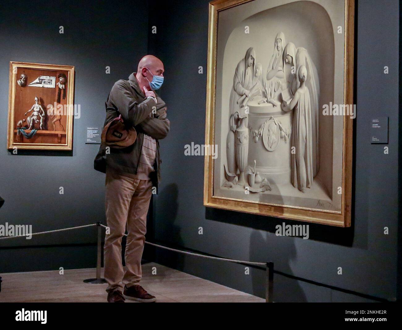 Visitors contemplate the works that are part of the exhibition ...
