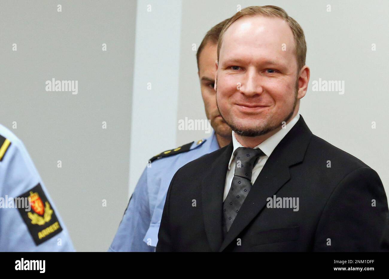 FILE - Confessed mass killer Anders Behring Breivik smiles as he ...
