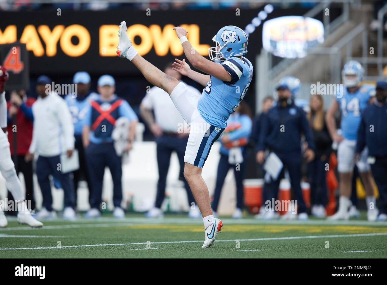 North Carolina Tar Heels punter Ben Kiernan (91) follows through on a ...