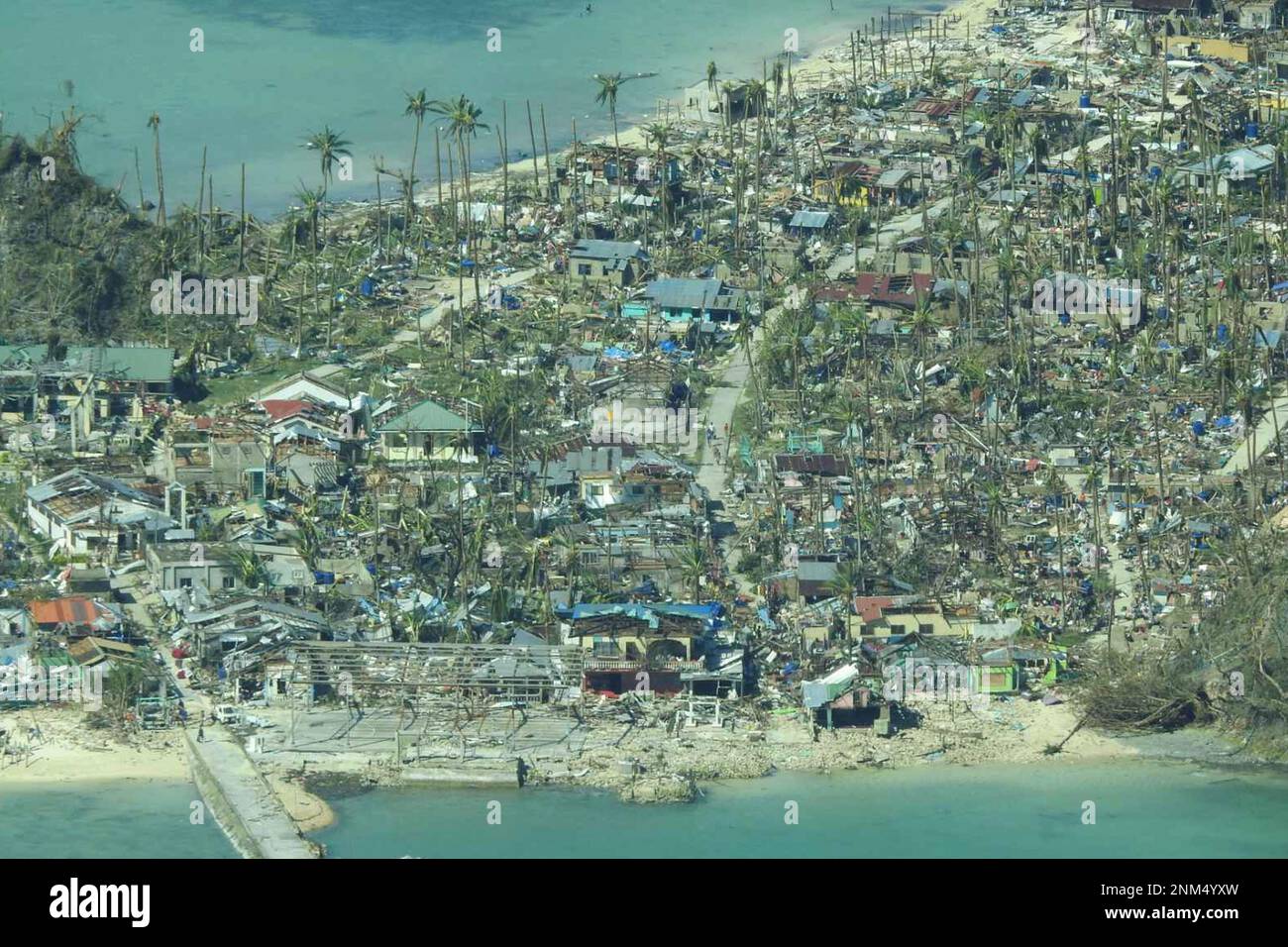 This photo provided by the Philippine Coast Guard, shows damaged houses ...