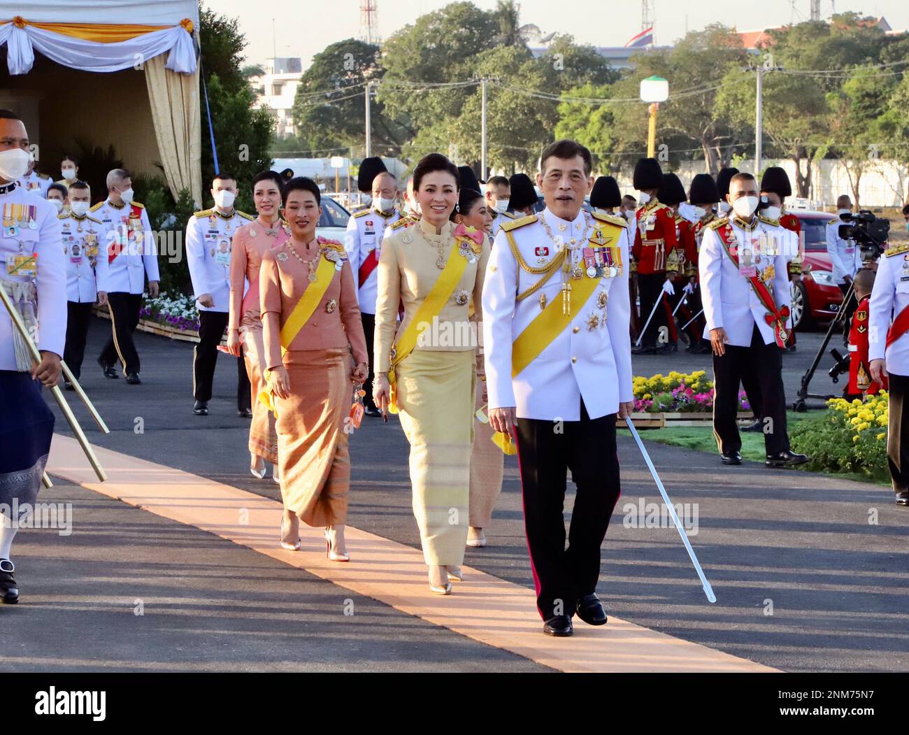Thailand's King Maha Vajiralongkorn followed by his wife Queen Suthida, and daughters Princess ...
