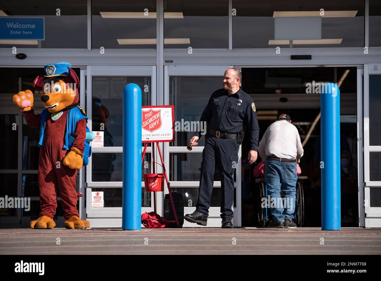 A Paw Patrol mascot waves at shoppers as Odessa Police Department Chief ...