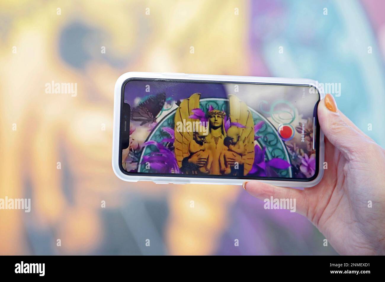 Kian Kamas, with the City of Tulsa, uses her phone to experience "The ...