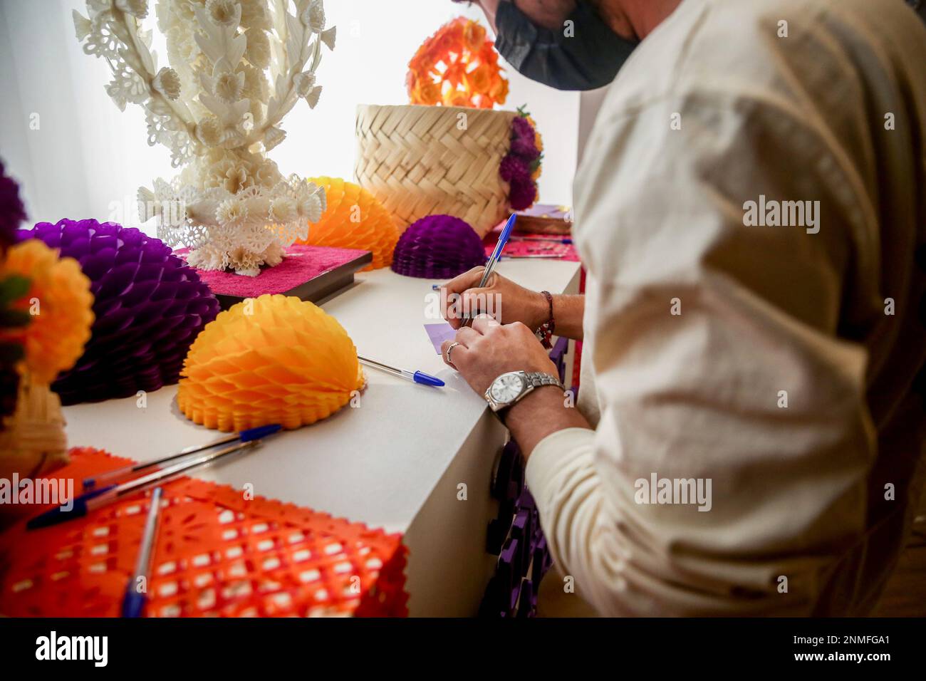 A man makes decorations for the exhibition 'Altar of the Dead', at the ...