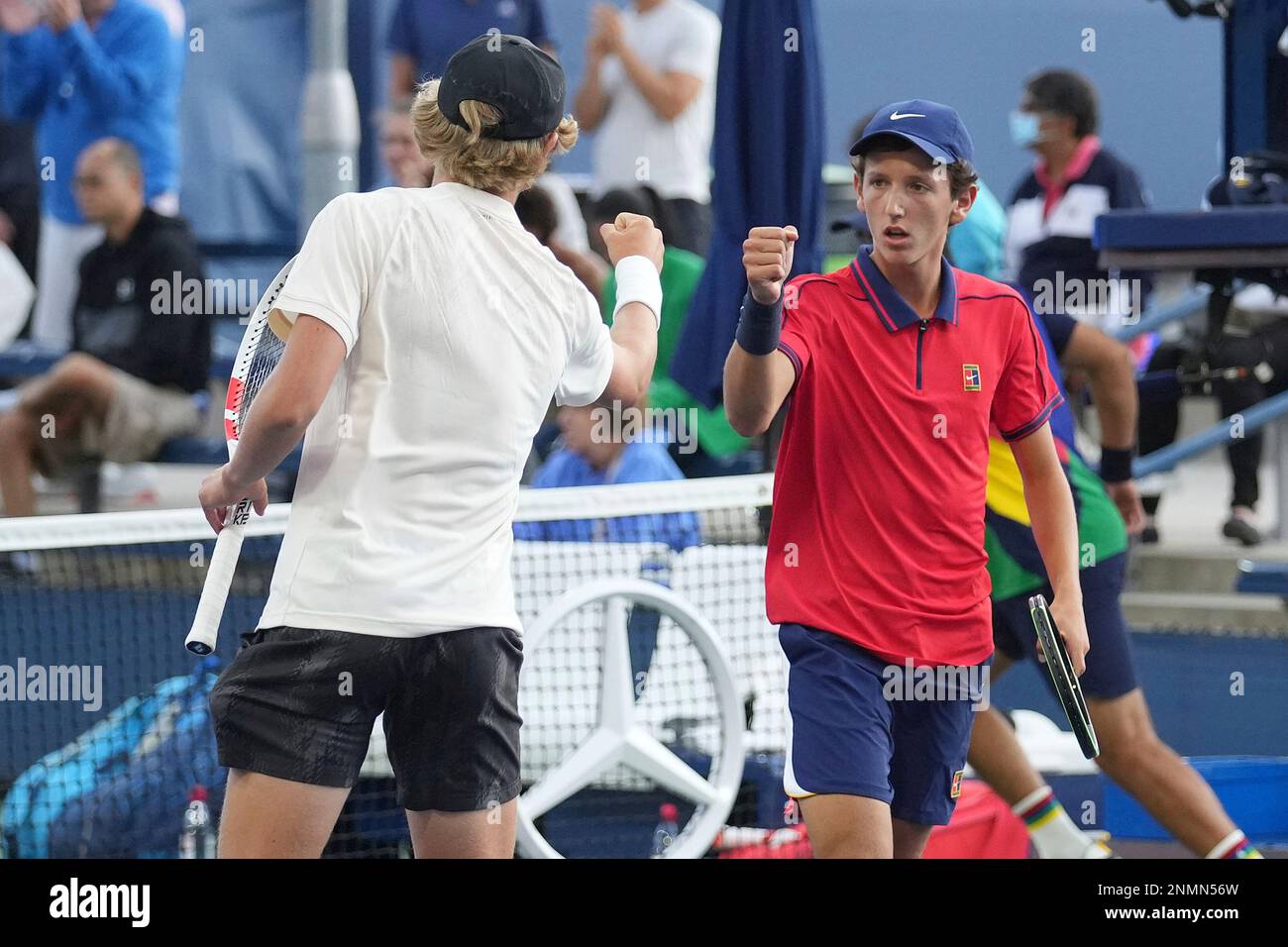 Ethan Quinn and Nicholas Godsick high five during a Junior Boys ...