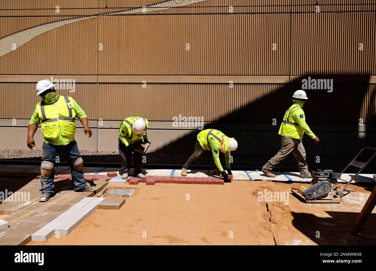 Construction workers remake the platform at DART's Mockingbird Station ...