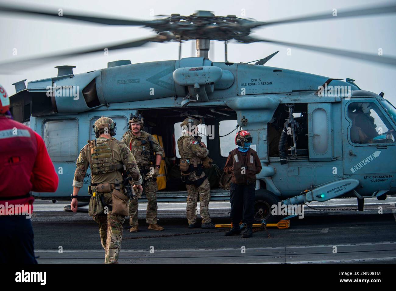In this photo provided by the U.S. Navy, sailors assigned to an ...