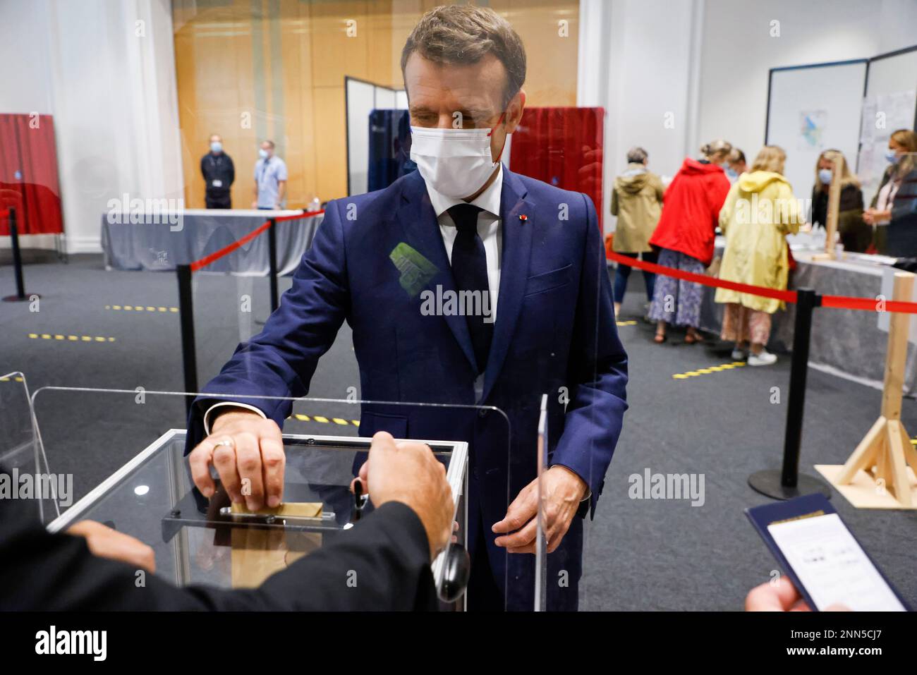 French President Emmanuel Macron casts a ballot for the second round of ...