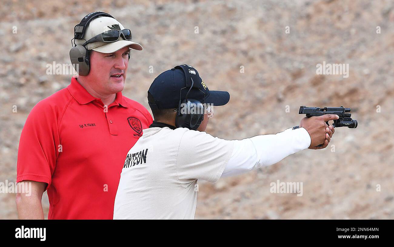 Yuma Police Department Sgt. Robert Trabue, left, works with Arizona ...