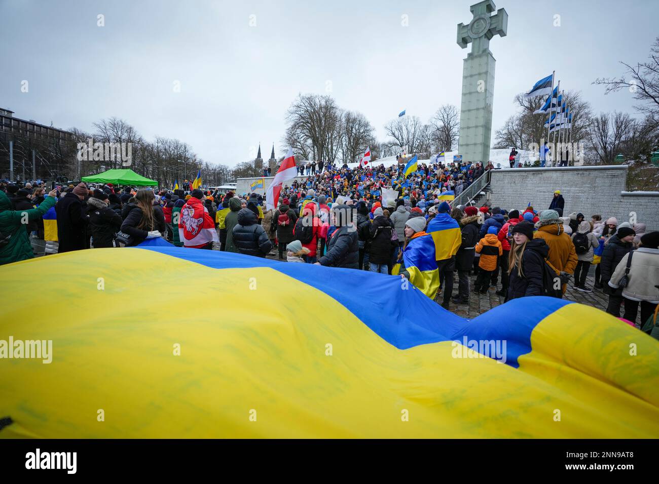 Ukrainians hold a giant Ukrainian flag during a demonstration marking the one year anniversary ...