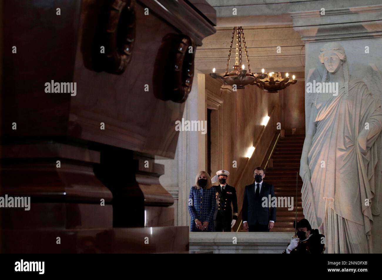 French President Emmanuel Macron and his wife Brigitte Macron stand by ...