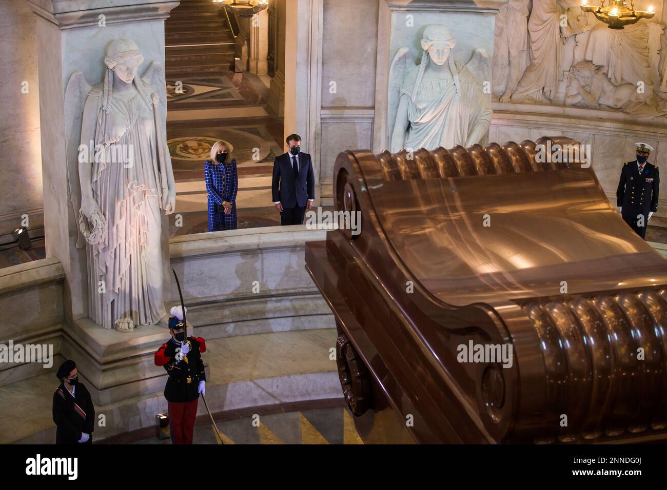 French President Emmanuel Macron and his wife Brigitte Macron stand by ...