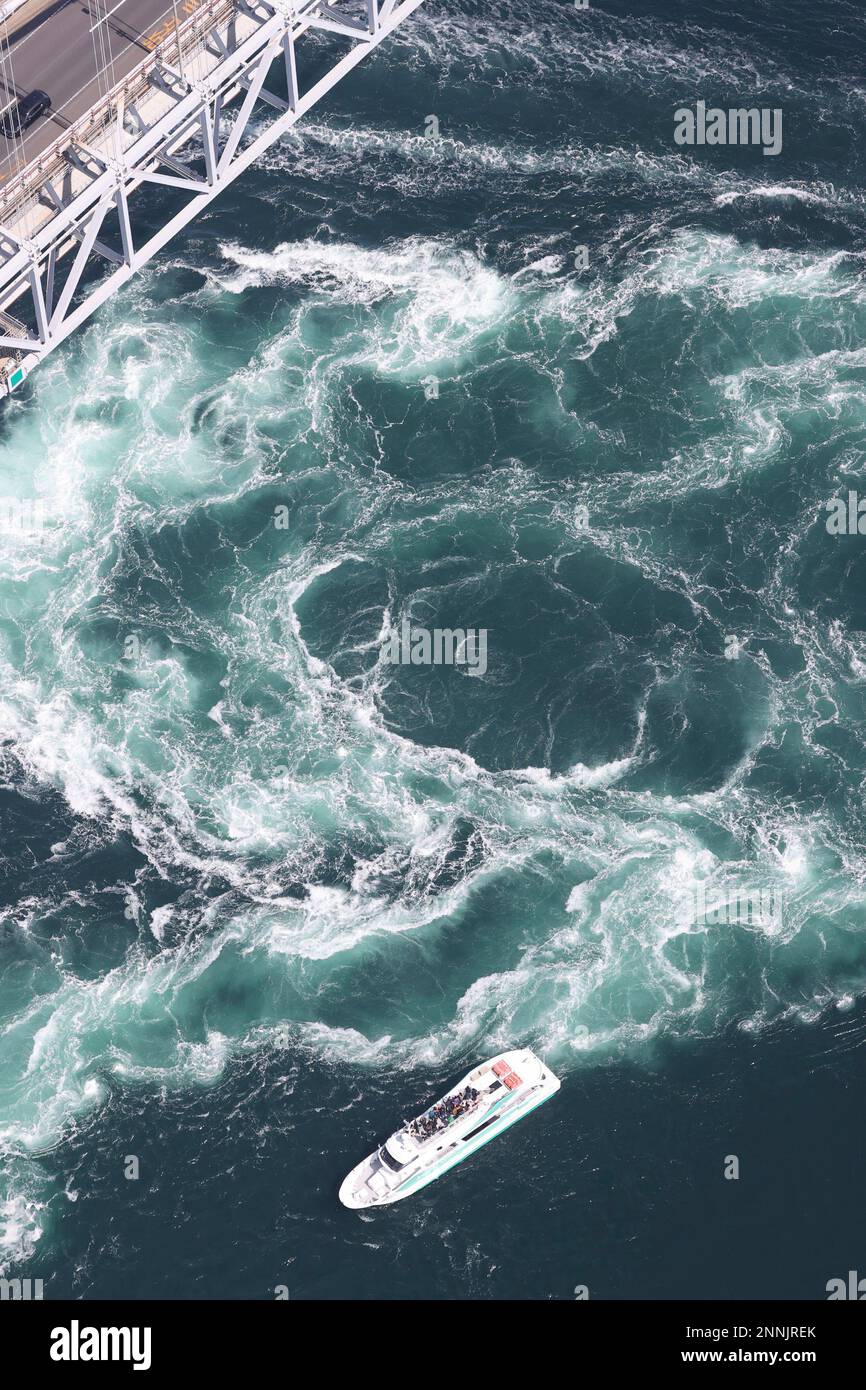 An aerial picture shows a tour boat cruising in the middle of Naruto ...
