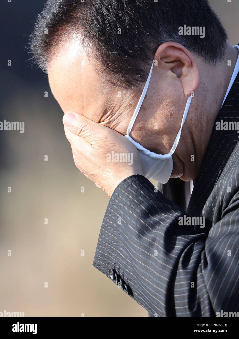 A man cries in front of the cenotaph for the victims of the Great East ...