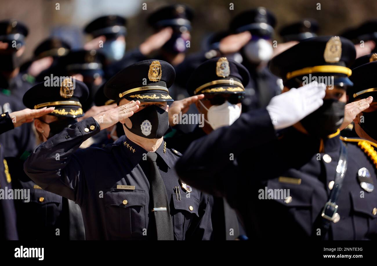 Dallas Police Chief Eddie Garcia (left) salutes alongside his comrades ...