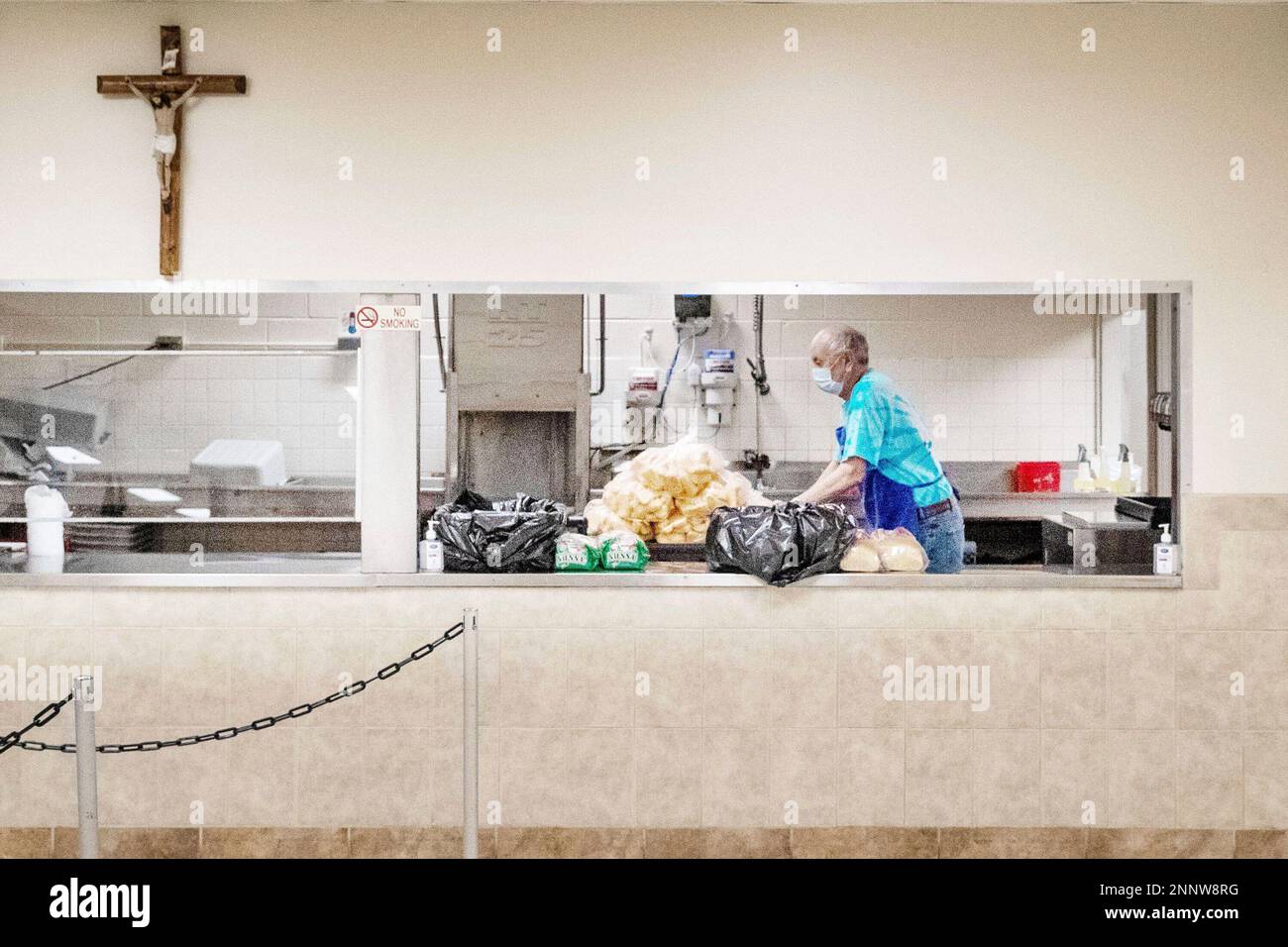 Michael Makara wheels back bags of frozen fish while preparing for a ...