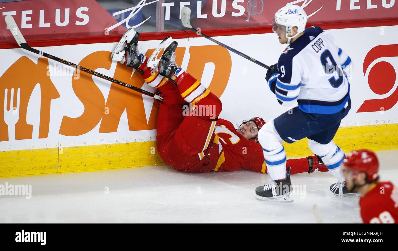 Winnipeg Jets' Andrew Copp, right, checks Calgary Flames' Matthew ...