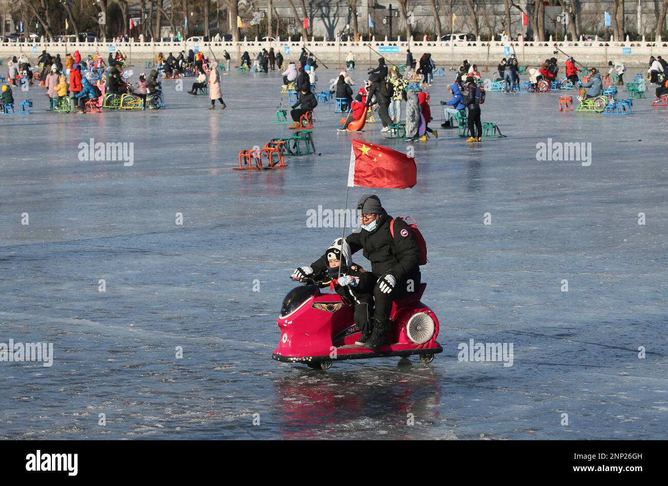 People wearing masks enjoy skating at Shichahai Ice Link, also known as ...