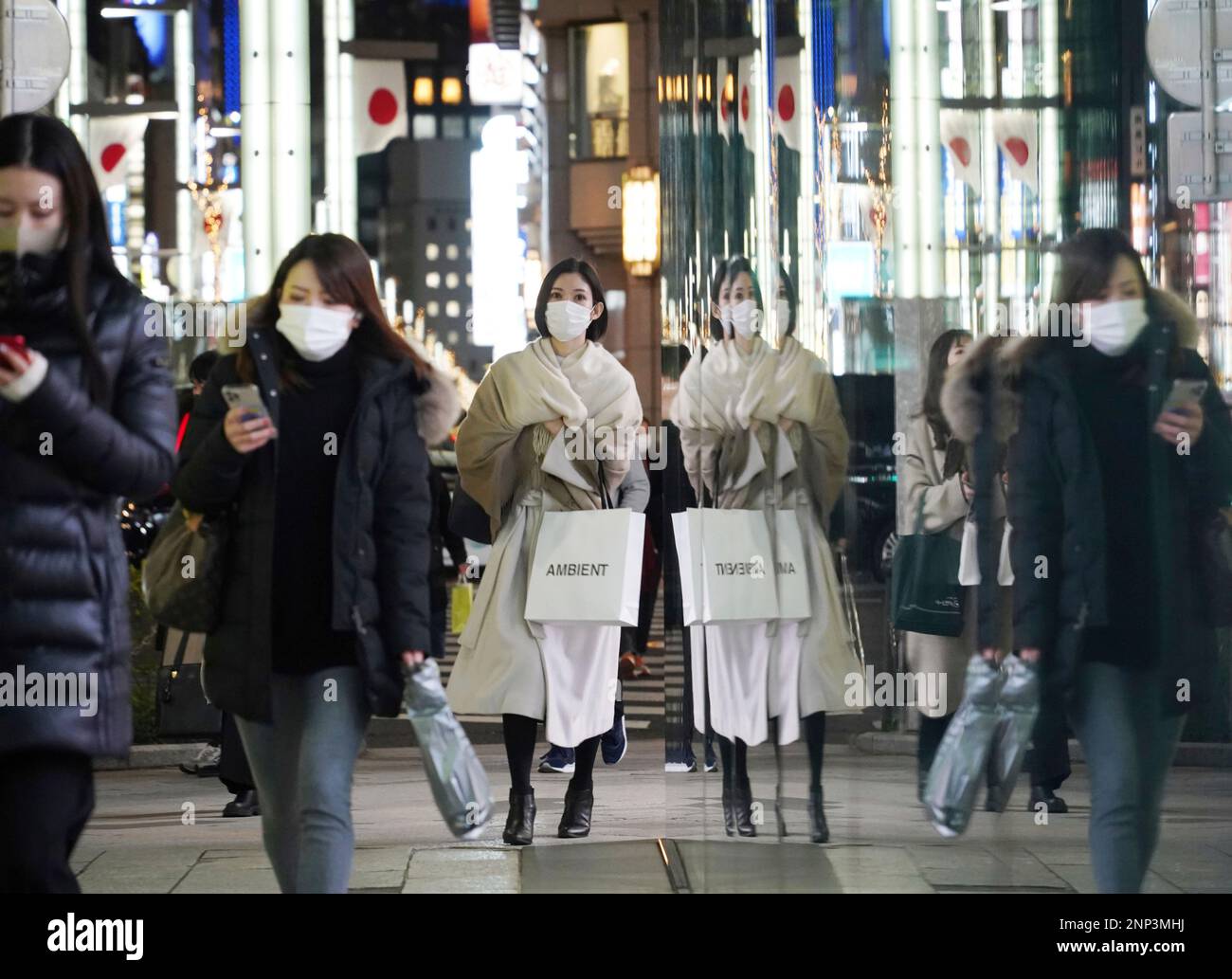 People wearing a face mask walk near Mitsukoshi Department store in ...