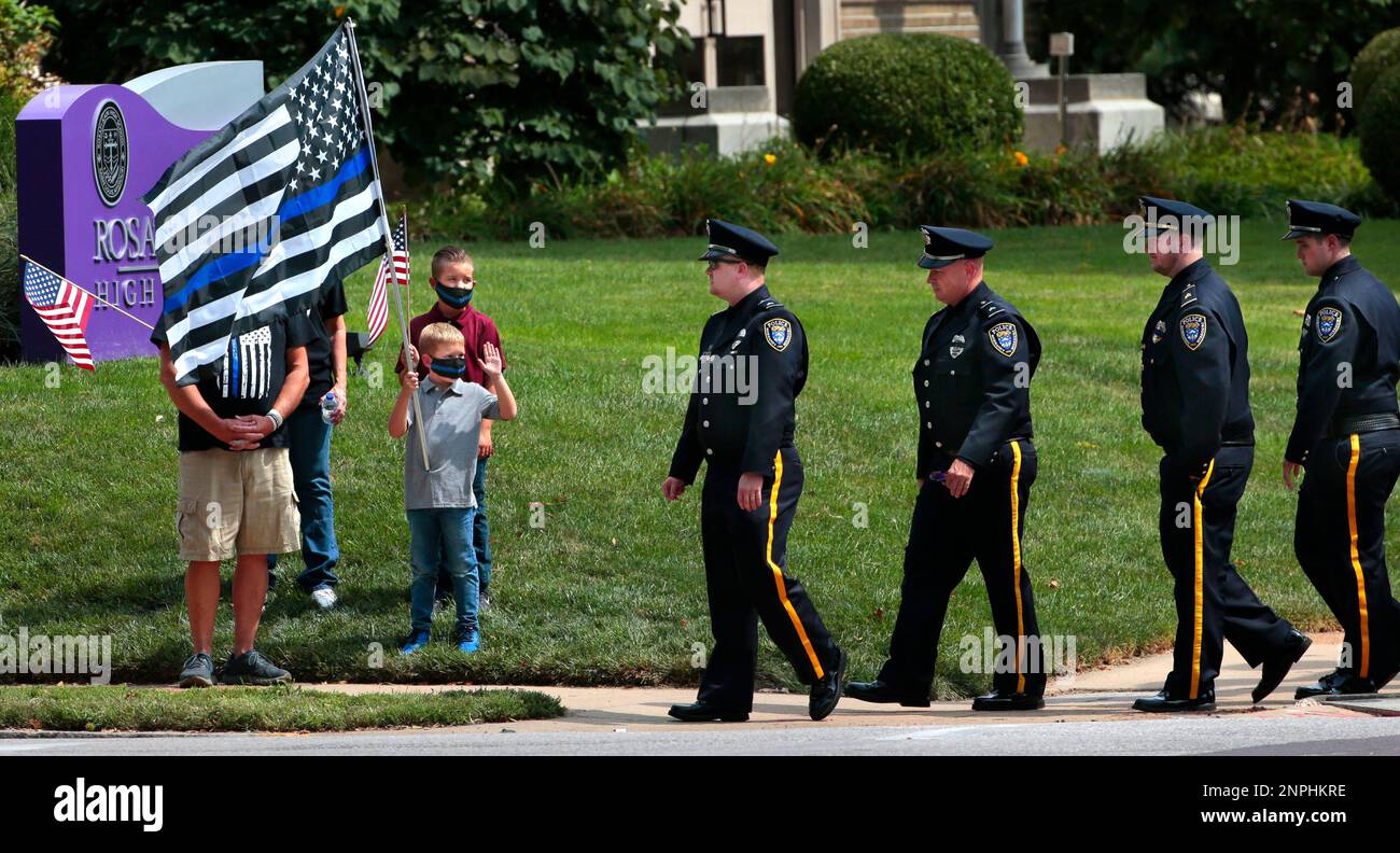 Normandy police officers are greeted by Logan, front, and Trenton Cox ...