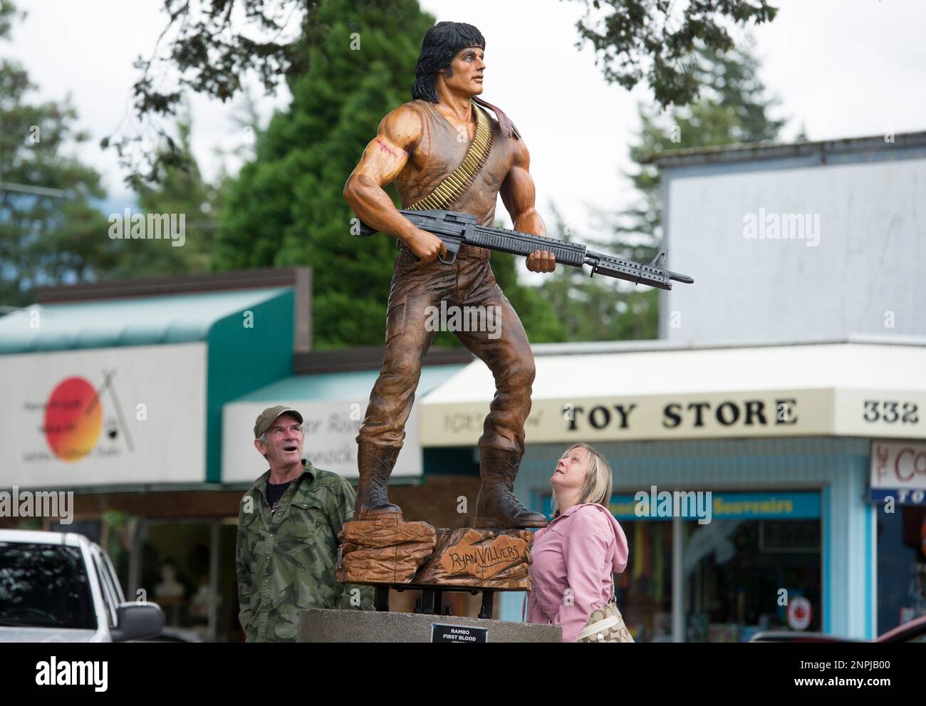 People look at a life-size chainsaw cut statue of Sylvester Stallone as ...