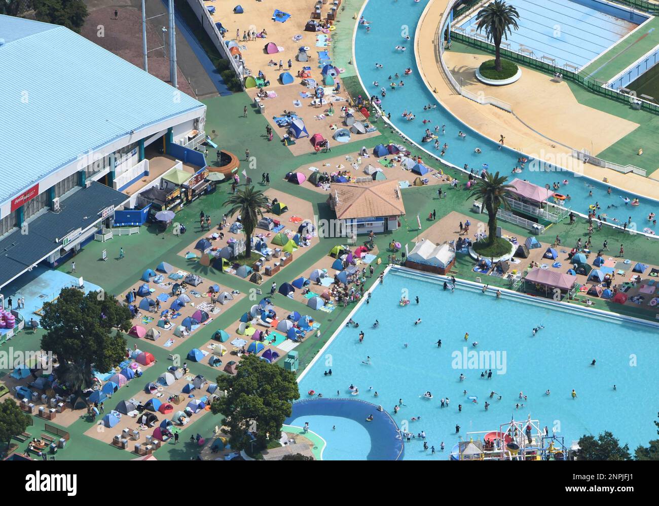 An aerial photo shows a swimming pool crowded at Toshimaen amusement ...