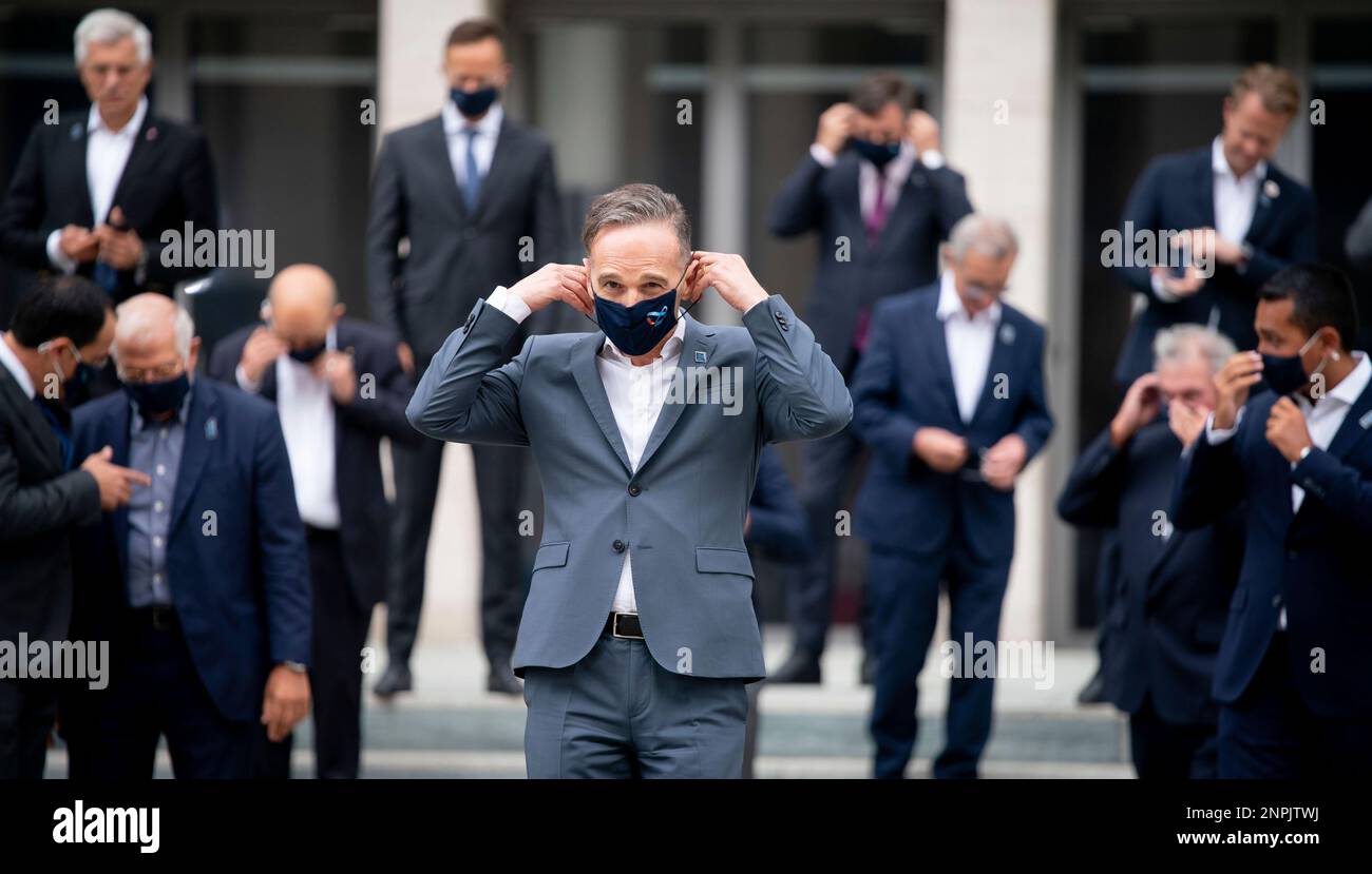Foreign Minister Heiko Maas, wearing a mouth-and-nose protector, meets his EU counterparts for ...