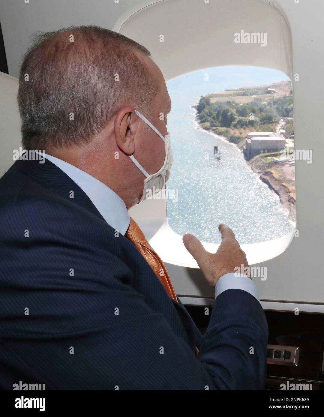 Turkey's President Recep Tayyip Erdogan looks out of a plane window at ...
