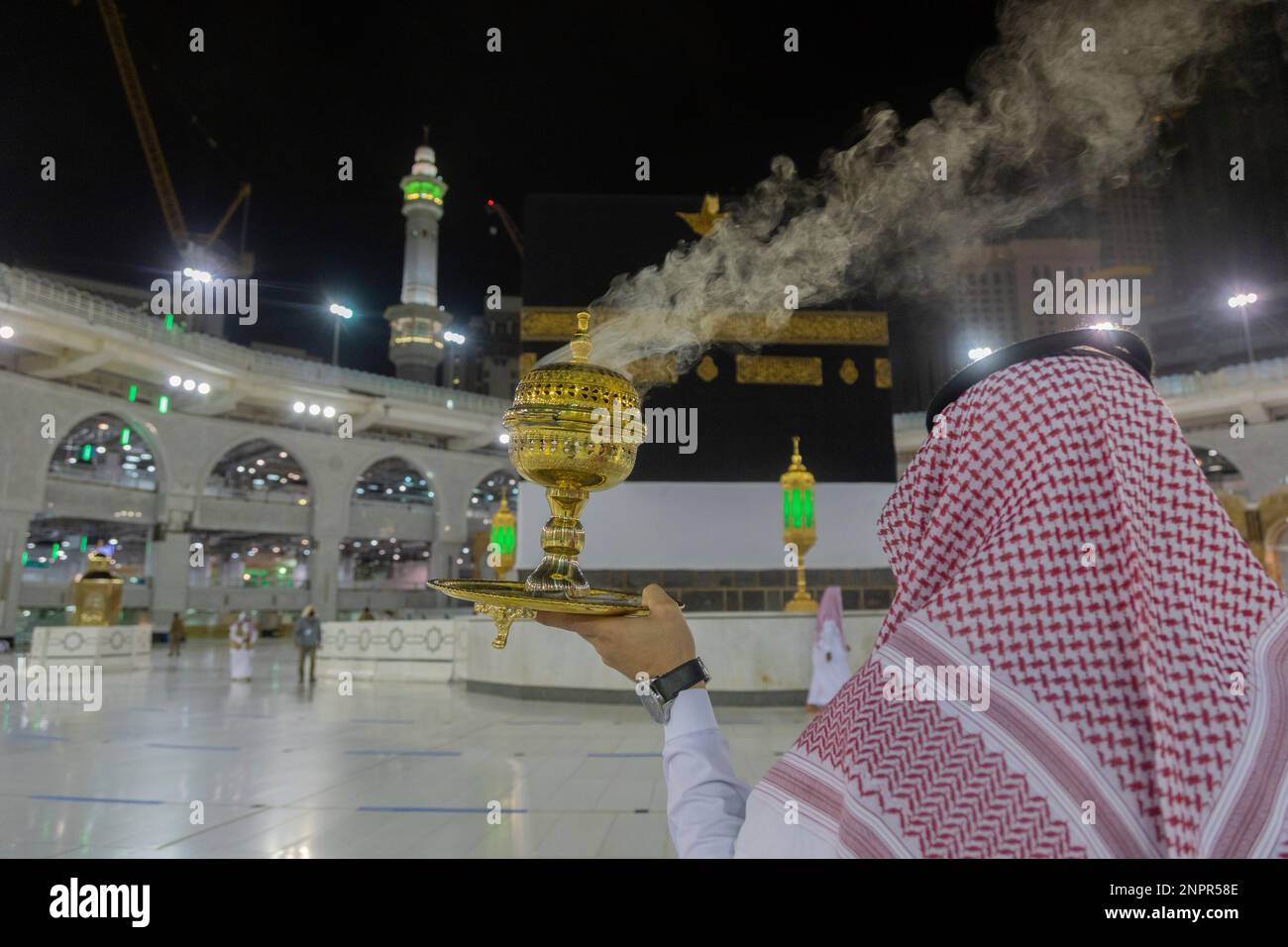 A man burns incense as the area around the Kaaba, the square structure ...