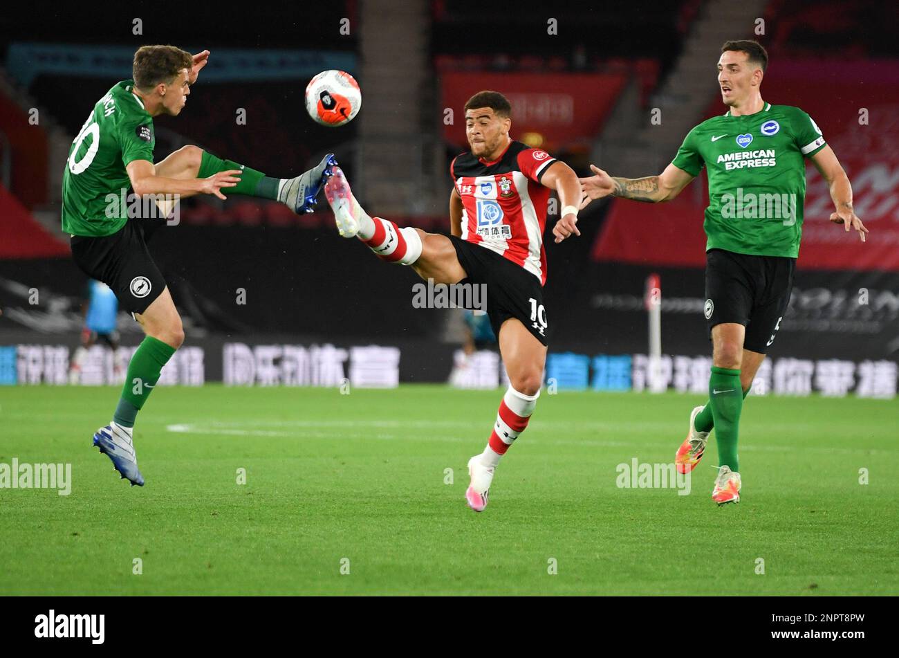 Southampton's Che Adams, centre, kicks at the ball as Brighton's Solly ...