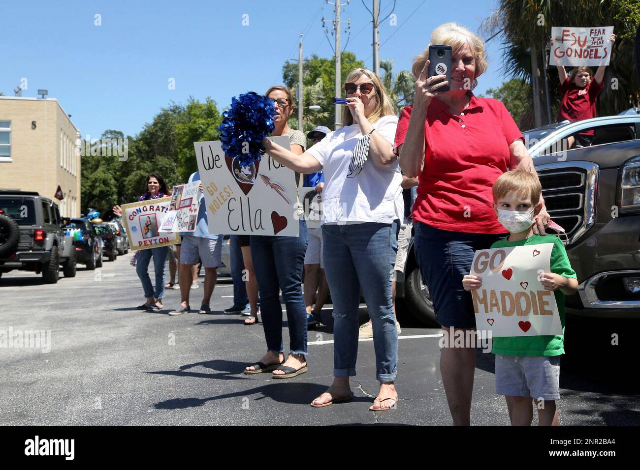 Parents, family and friends observe social distancing guidelines while ...