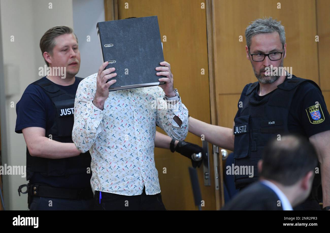At the opening of the trial, the defendant covers his face with a ...