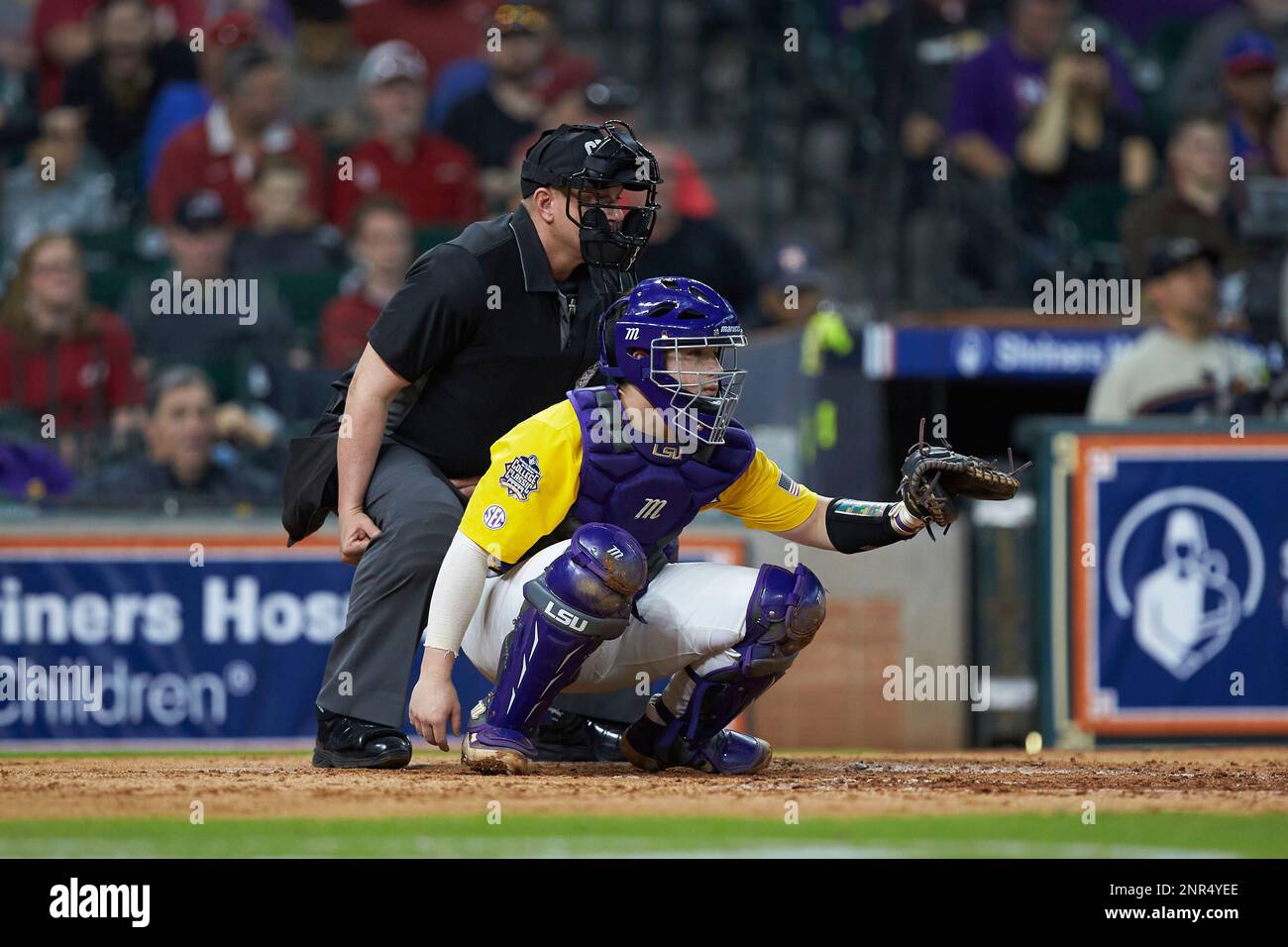 LSU Tigers catcher Alex Milazzo (20) sets a target as home plate umpire Ken Langford looks on ...