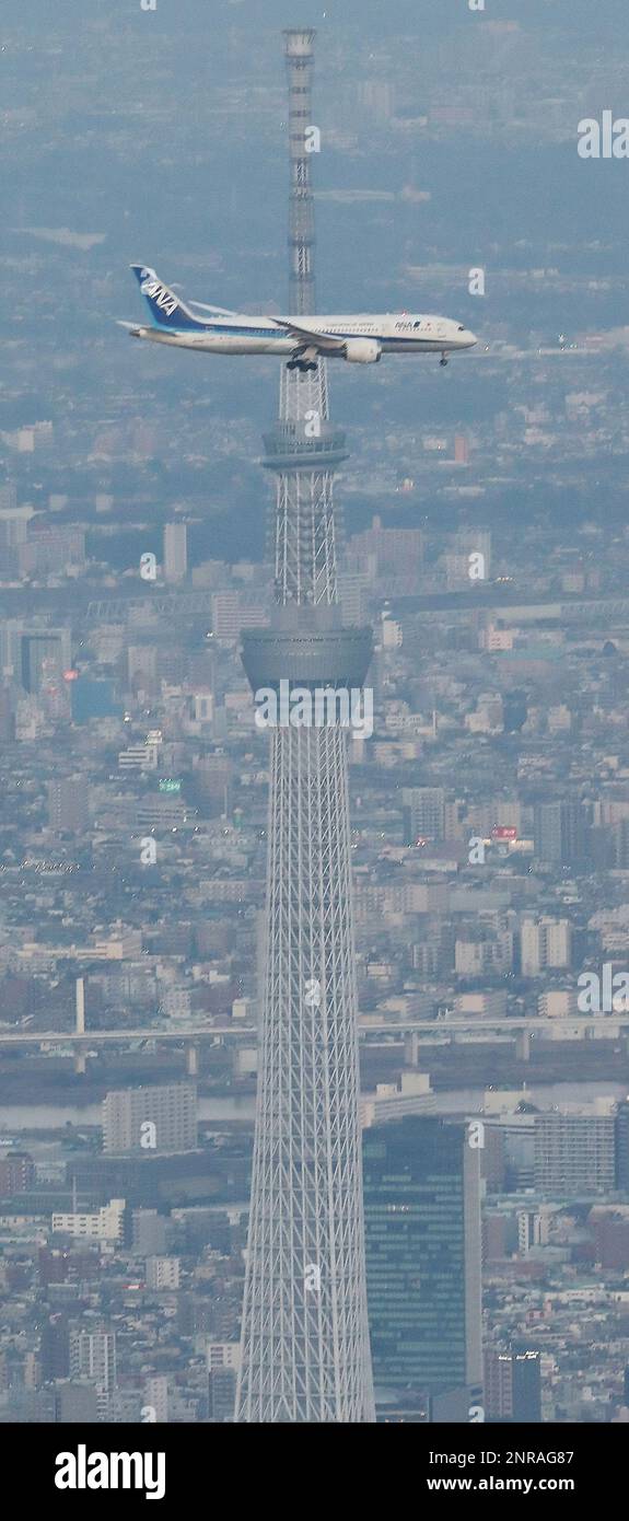 An airplane is flying over Tokyo Skytree in Sumida Ward on Feb.2, 2020 ...